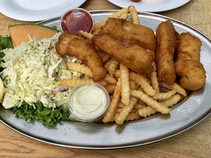 Golden-battered cod that shatters like glass reveals pearly white fish within – the seafood equivalent of breaking into a crème brûlée.