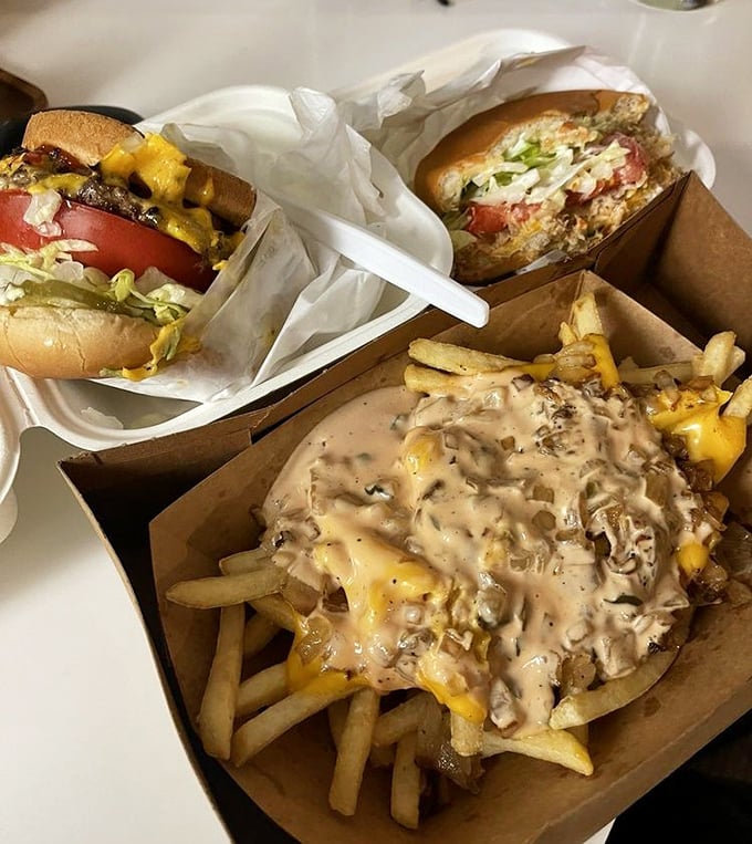 The holy trinity of comfort food: burgers, chili cheese fries, and zero pretension. This isn't a meal—it's edible therapy served in unpretentious cardboard containers.