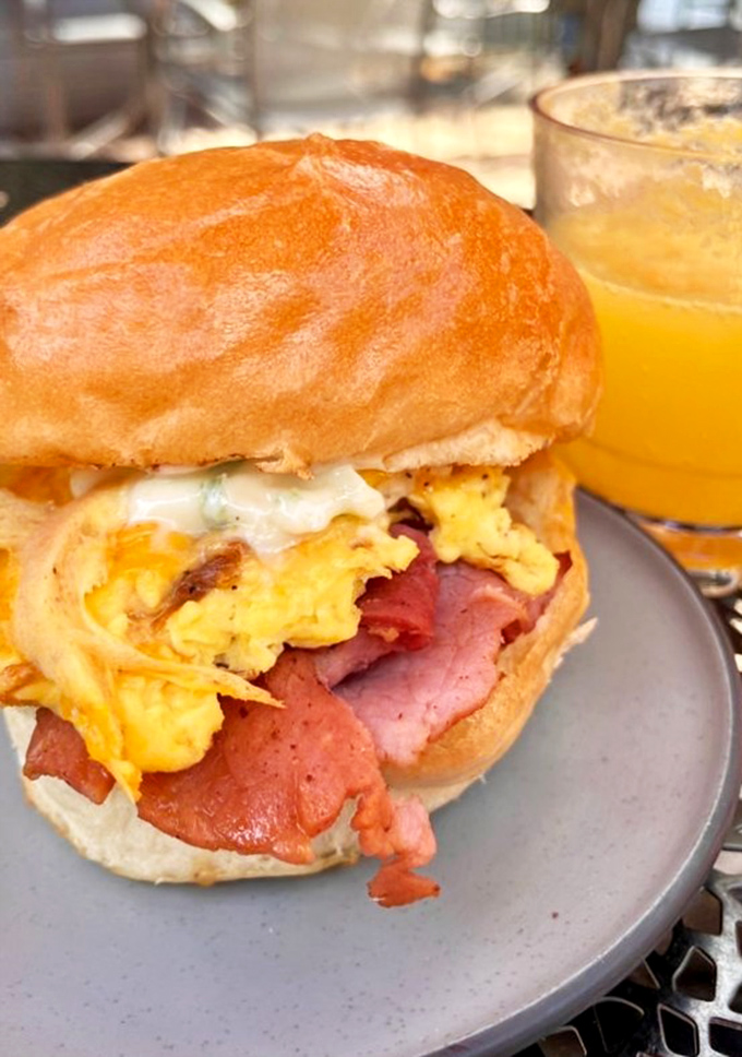 The sandwich that launched a thousand road trips. That golden brioche bun cradling eggs and meat like they're precious cargo – which, let's be honest, they are.
