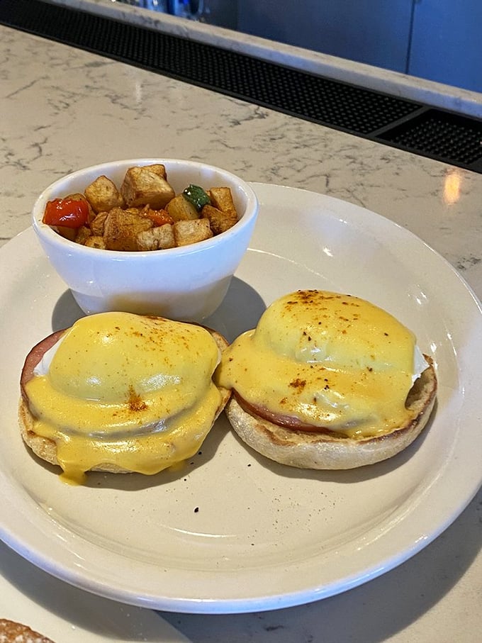 Classic eggs Benedict executed with textbook perfection—the hollandaise sauce practically performing Swan Lake across those English muffins.