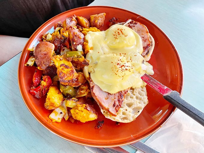 Eggs Benedict done right—perfectly poached eggs perched atop Canadian bacon with hollandaise that would make a French chef nod in approval.