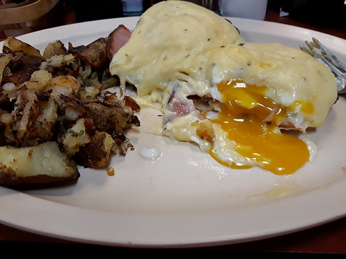 Eggs Benedict with perfectly runny yolks cascading over ham and English muffins. The hash browns aren't an afterthought—they're a supporting star.
