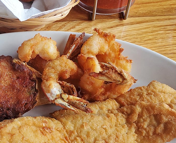These fantail shrimp aren't just fried – they're transformed into crispy, golden treasures that snap between your teeth with oceanic sweetness.