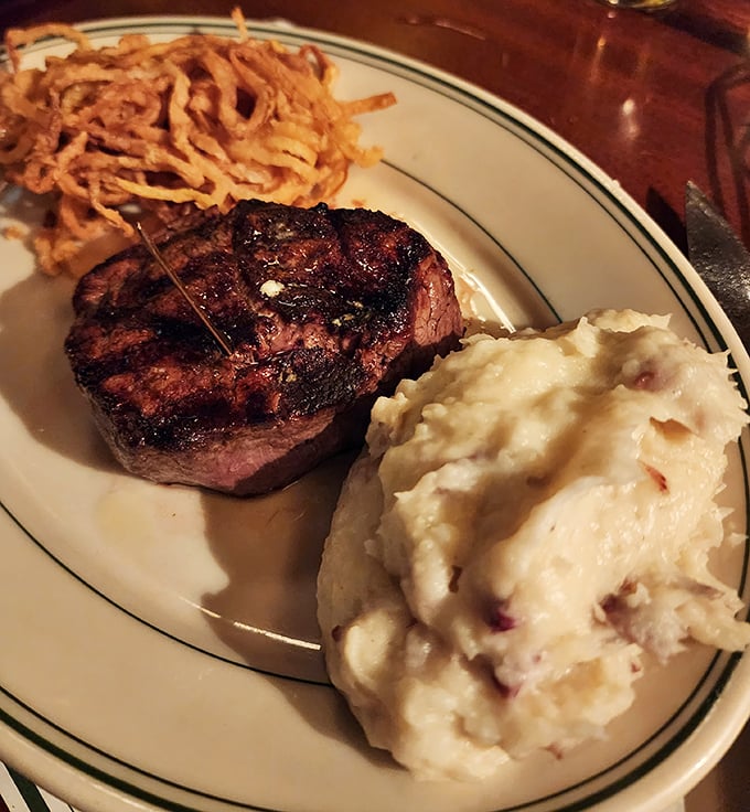 Behold the filet mignon in its natural habitat—perfectly charred exterior, tender pink center, with sides that know their supporting role.