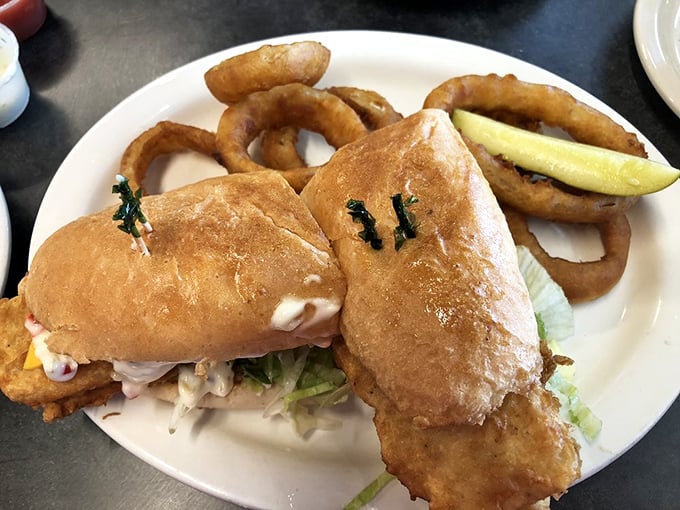 This isn't just a sandwich; it's an architectural achievement of crispy fish, fresh toppings, and pillowy bread that puts ordinary lunch to shame.