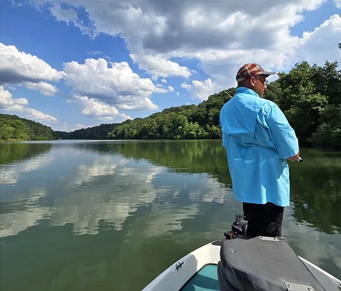 The patient angler waits. At Strouds Run, fishing isn't just about catching—it's about that perfect moment of zen on the water.