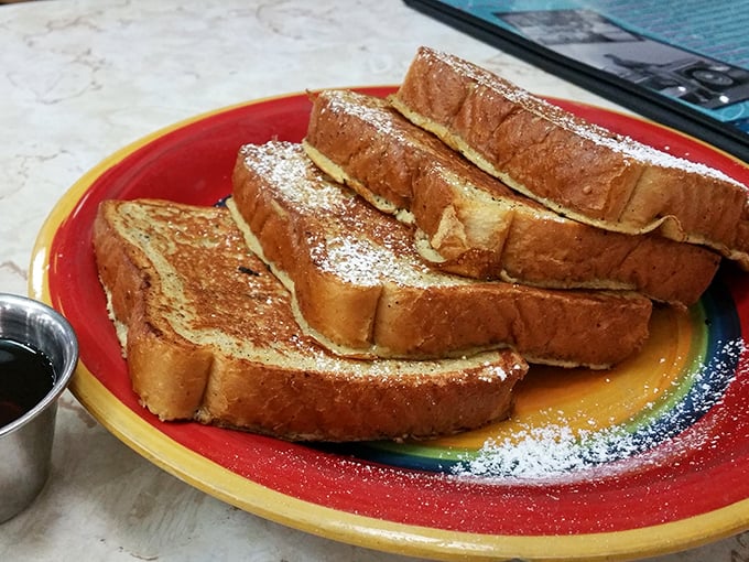 Golden-brown French toast dusted with powdered sugar—proof that simplicity, when done right, can outshine complexity every time. Maple syrup: nature's liquid gold.