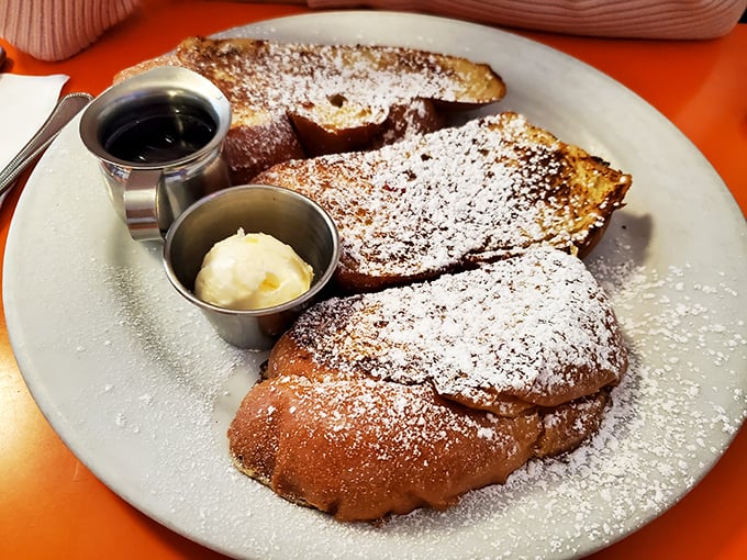 The French toast at Rudy's wears its powdered sugar like a winter coat, with maple syrup and butter standing by for extra warmth.