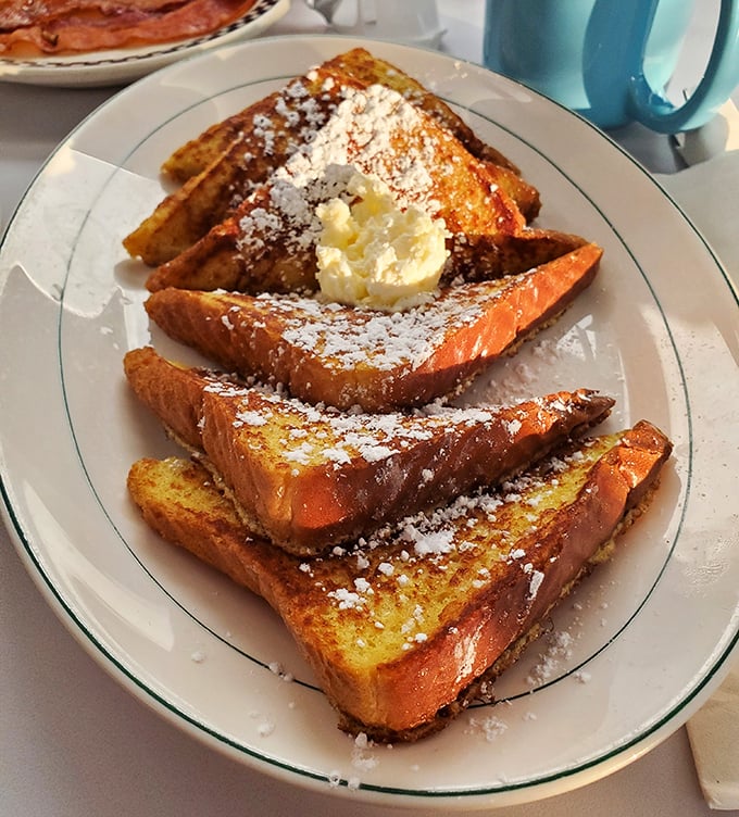 French toast that doesn't need a passport to impress—golden, crispy edges with a custardy center that puts ordinary breakfast to shame.