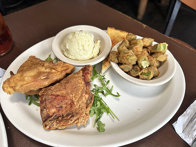 Southern fried chicken that doesn't need fancy plating to impress. Golden, crispy perfection alongside creamy mashed potatoes and fried okra—comfort on a plate.