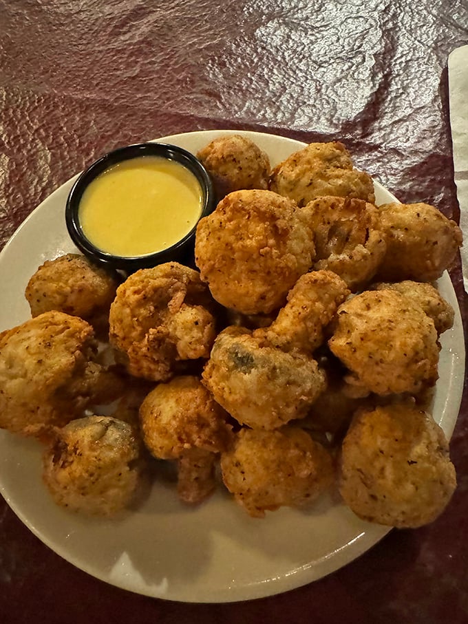 These golden-fried mushrooms aren't just appetizers – they're little flavor bombs that make waiting for your steak feel like part of the adventure.