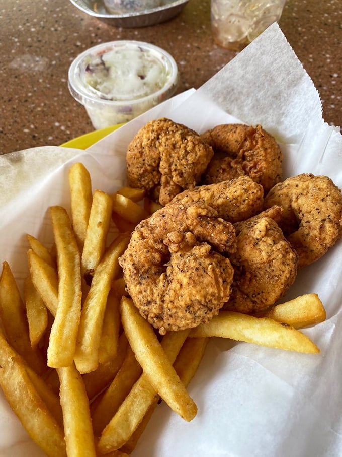 Golden-fried shrimp that snap between your teeth, paired with crispy fries and homemade slaw – the holy trinity of Florida seafood shacks.