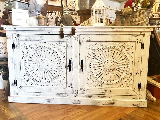 This distressed white cabinet with intricate sunburst carvings isn't just furniture—it's a conversation piece with more character than a Tennessee Williams play.