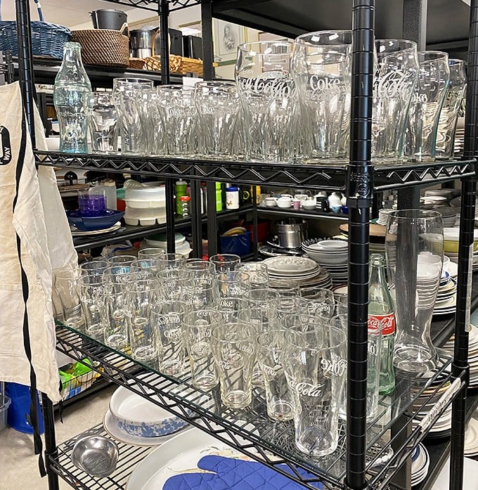 Coca-Cola glasses lined up like soldiers ready for duty—because every Florida kitchen needs glassware with personality, not just function. 