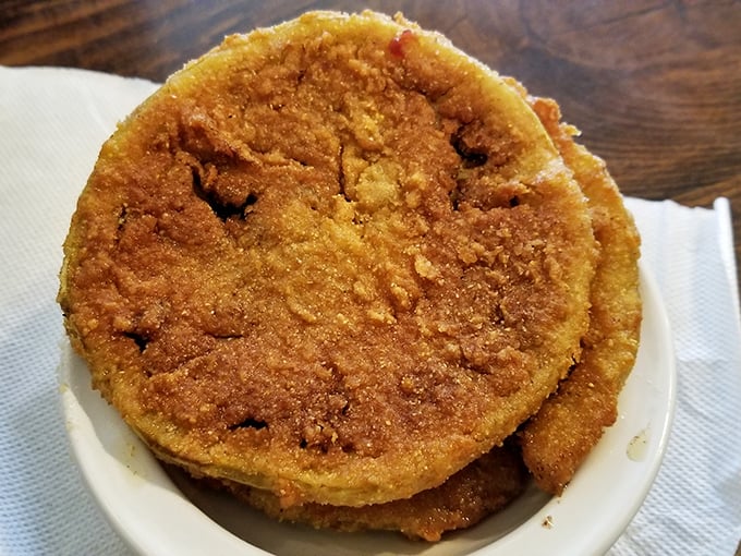 These aren't just fried green tomatoes; they're edible Southern history—crispy, tangy discs that make you wonder why we ever eat them red.