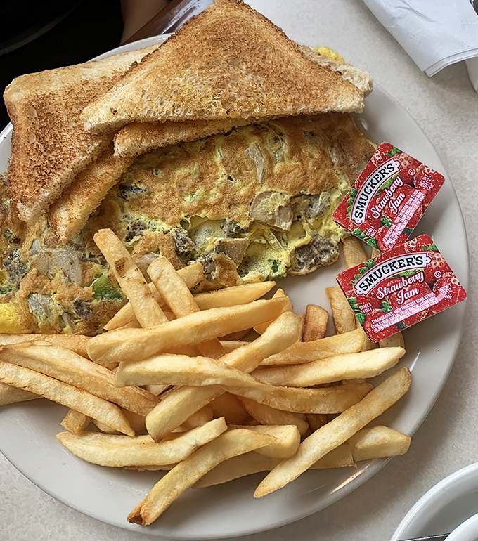 This isn't just an omelet—it's a morning masterpiece with toast sentries standing guard, ready to soak up every last delicious morsel.