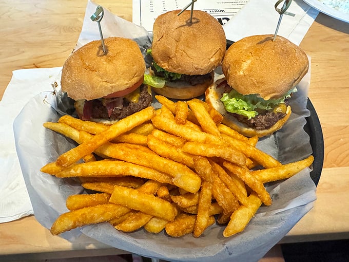 Burger sliders that don't slide on flavor – these hand-formed beauties arrive with golden fries that deserve their own fan club.