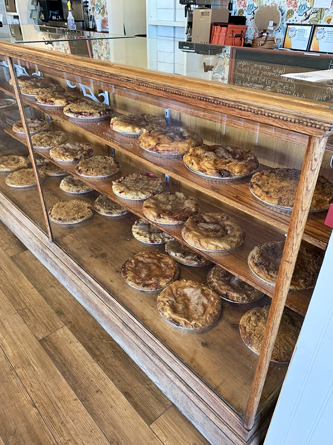 The display case – a museum of edible art where fruit, cream, and nut masterpieces await adoption by hungry patrons.