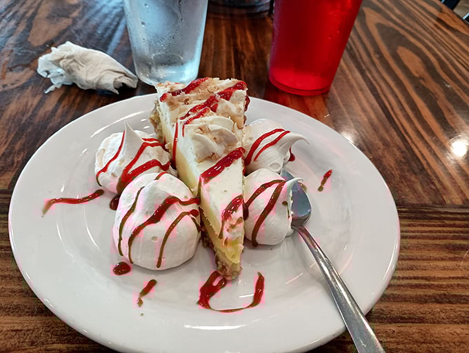 Key lime pie that makes time stand still – creamy, tart-sweet filling, dollops of whipped cream, and that artistic raspberry drizzle. Worth every single calorie and then some.