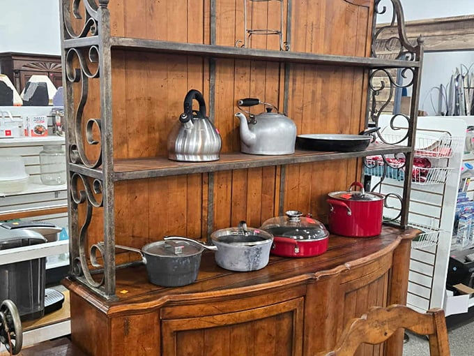 Vintage kettles and modern cookware cohabitate on this rustic hutch—like "The Odd Couple" but with better kitchen credentials.