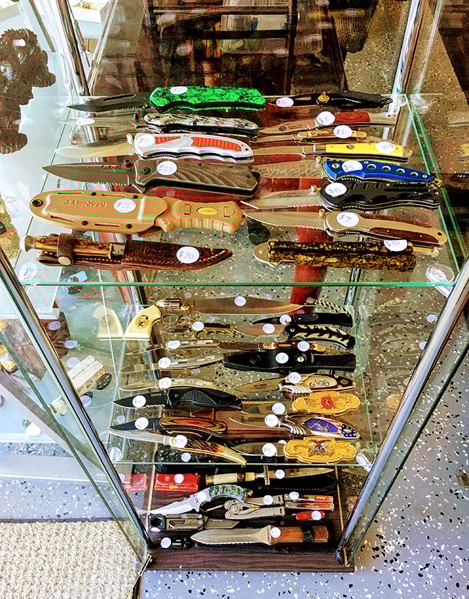 This knife display case isn't just selling cutlery – it's offering conversation pieces with handles more colorful than a Florida sunset.
