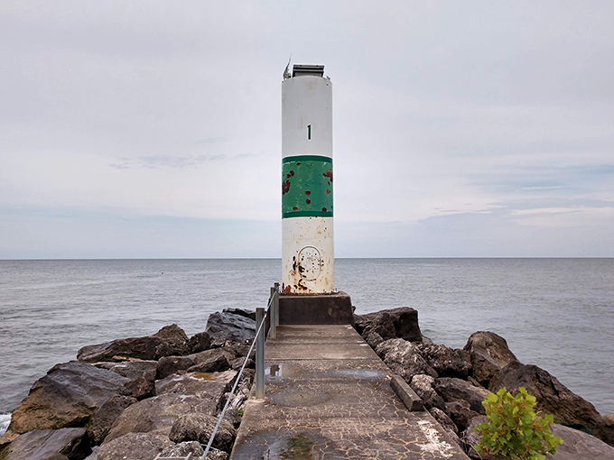 This stalwart lighthouse stands guard where lake meets sky, guiding adventures and collecting stories from generations of visitors.