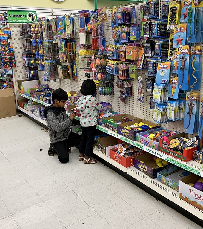 Young treasure hunters navigate the toy section with the serious concentration of archaeologists on the verge of discovery.