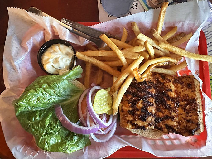 The Mahi sandwich arrives like a postcard from paradise—perfectly grilled, nestled on a bun with all the fixings a fish this good deserves.