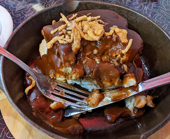 Comfort food architecture at its finest—layers of meatloaf, mashed potatoes, and gravy creating a savory skyscraper that demands to be demolished.