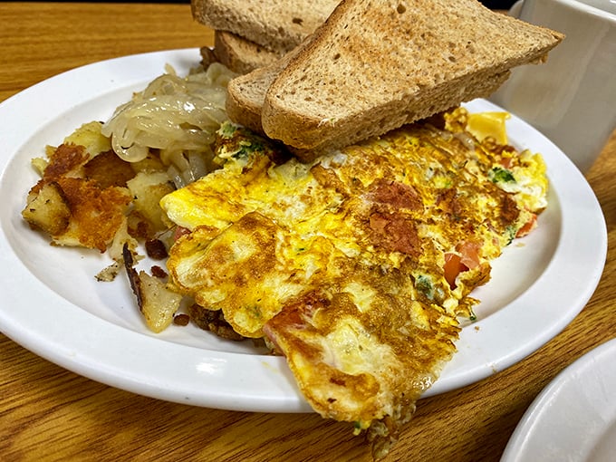 This omelet has achieved that mythical balance—crisp at the edges, fluffy within, and stuffed with fillings that complement rather than overwhelm.