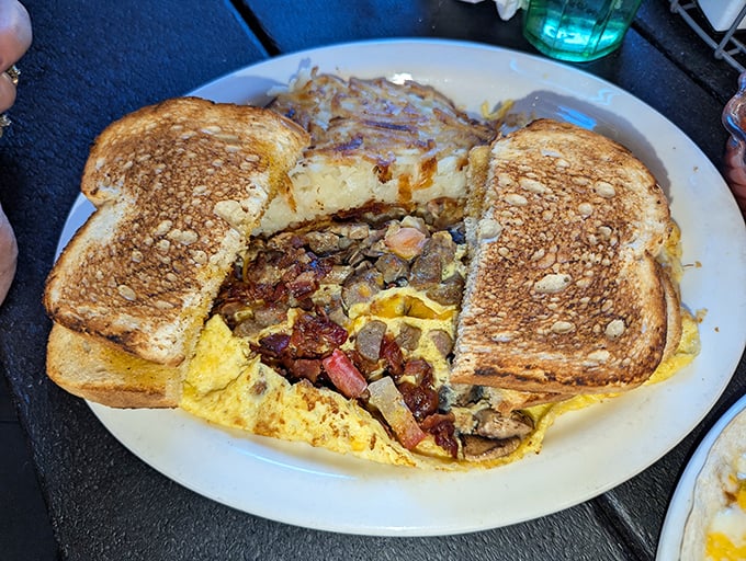 Breakfast alchemy at its finest – eggs, toast, hash browns, and assorted breakfast meats converge in a symphony of morning deliciousness.
