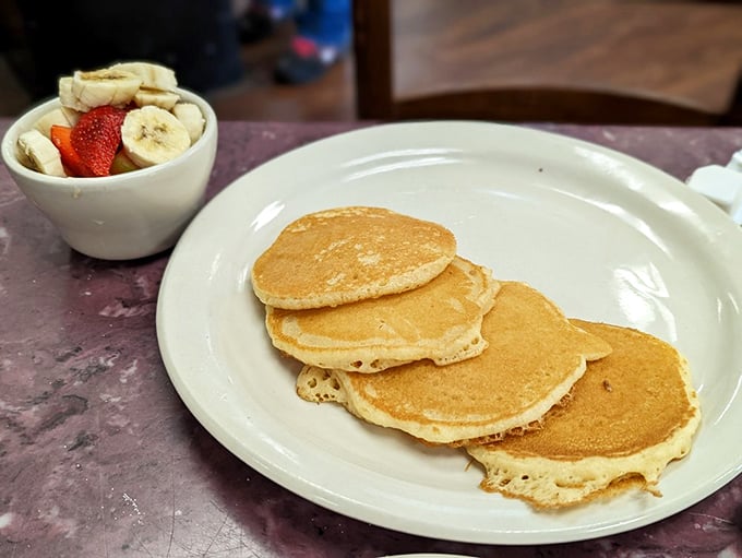 Pancakes so perfectly golden they could make a waffle jealous, served with fresh fruit that almost – almost – makes this breakfast healthy.