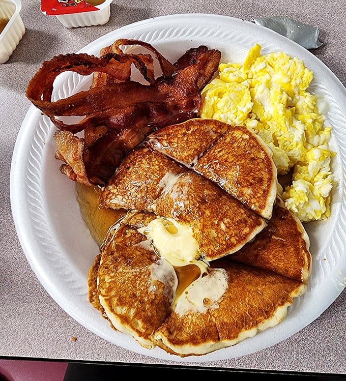 Golden pancakes with a pat of melting butter, crispy bacon, and fluffy eggs—the breakfast trinity that makes mornings worth facing.