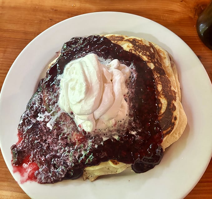 Berry-drenched pancakes that make you understand why bears spend all summer foraging – one bite and you'll be planning your hibernation around their breakfast hours.