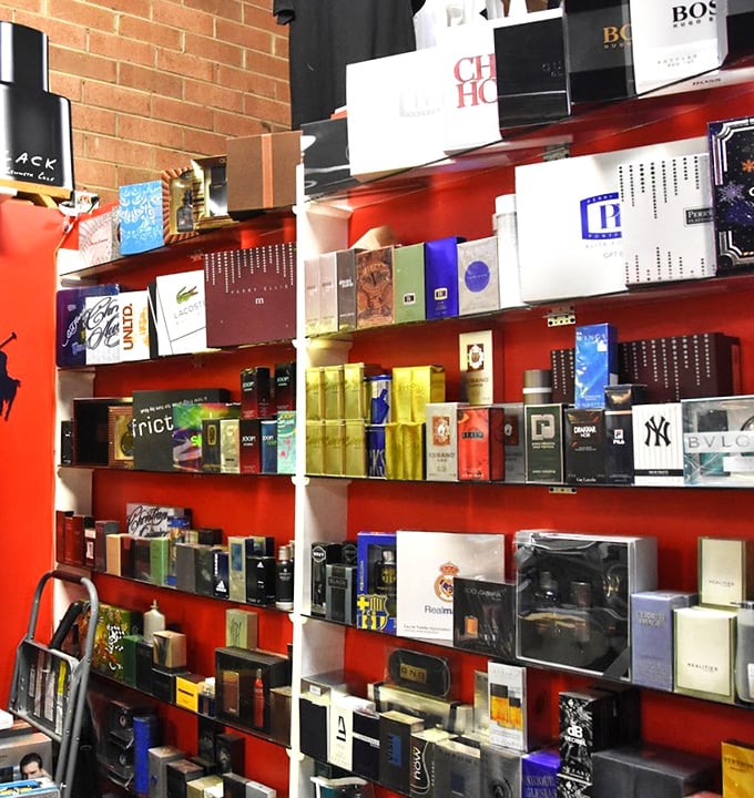 A rainbow explosion of designer fragrances lines these shelves, offering scents from "First Date" to "Midlife Crisis."