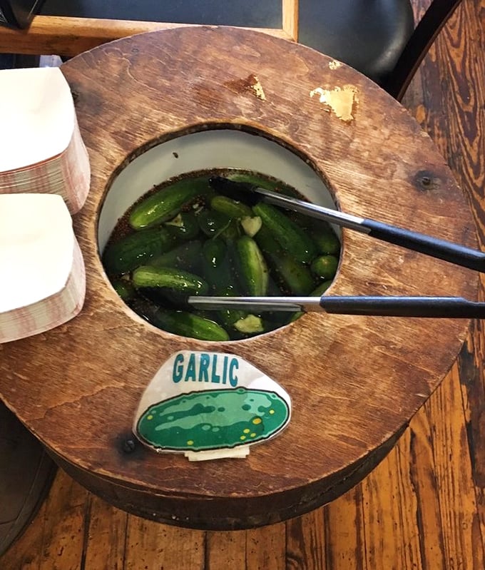 The pickle barrel—where garlic-infused cucumbers go for their spa treatment. These aren't just condiments; they're supporting characters in your sandwich story.