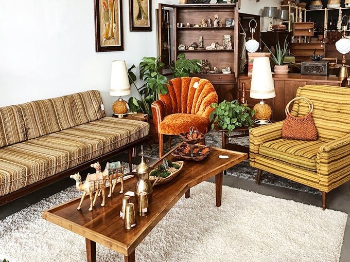 This isn't a living room setup—it's a time machine to 1968. That orange channel-back chair is practically begging for a martini.
