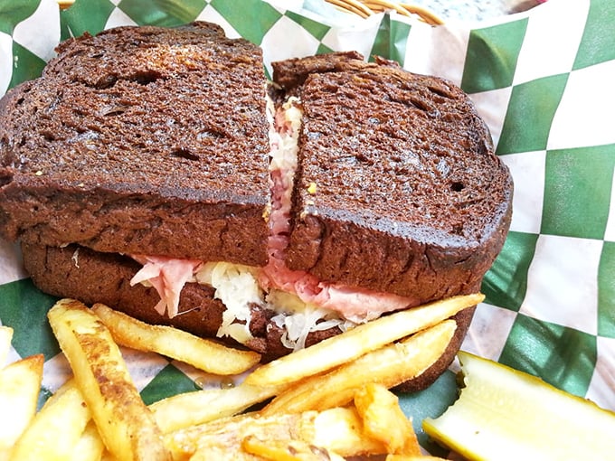 The Reuben on pumpernickel arrives like a delicious skyscraper of flavor – where corned beef and sauerkraut meet in perfect harmony.
