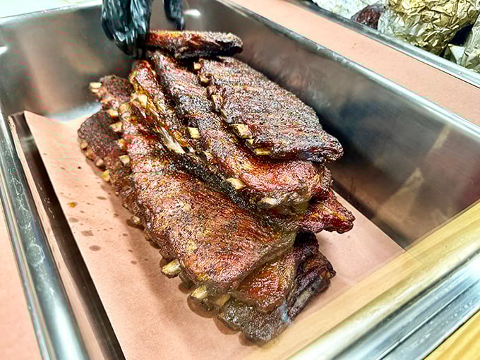 These ribs don't just fall off the bone – they dance away with dignity, their bark crackling with secrets only pitmasters know.