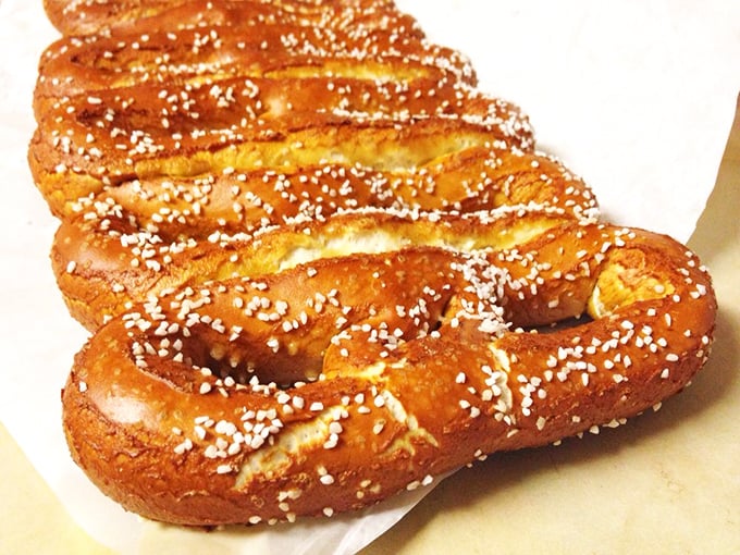 The perfect salt-to-dough ratio is culinary mathematics at its finest. That mahogany sheen comes from a traditional lye bath—pretzel science at work. 