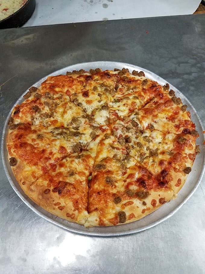This isn't just any pizza—it's Ohio-style thin crust with those perfect little sausage nuggets that crisp up at the edges. Poetry in circular form.