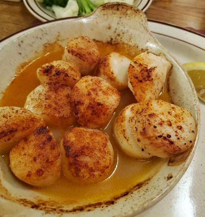 These seared scallops aren't just seafood—they're buttery little islands of joy swimming in a sea of savory sauce.