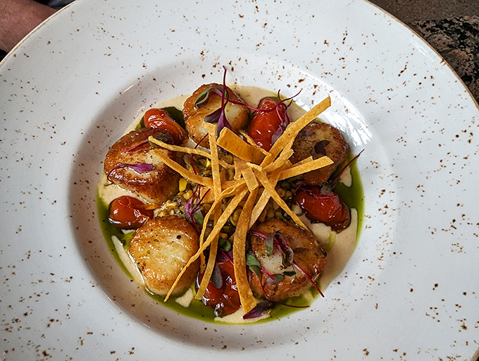 Scallops seared to golden perfection, surrounded by roasted tomatoes and crispy tortilla strips – ocean meets garden meets art.
