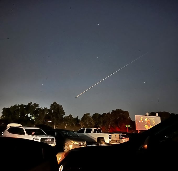 Nature provides the special effects as a shooting star streaks above the drive-in screen—a cosmic double feature no CGI could replicate.