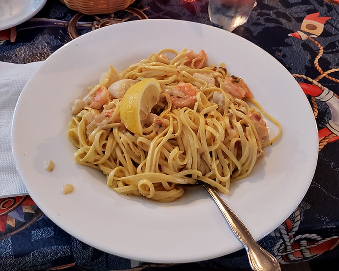 Shrimp linguine that would make an Italian grandmother nod in approval. That lemon wedge isn't just garnish – it's the sunshine this pasta deserves.