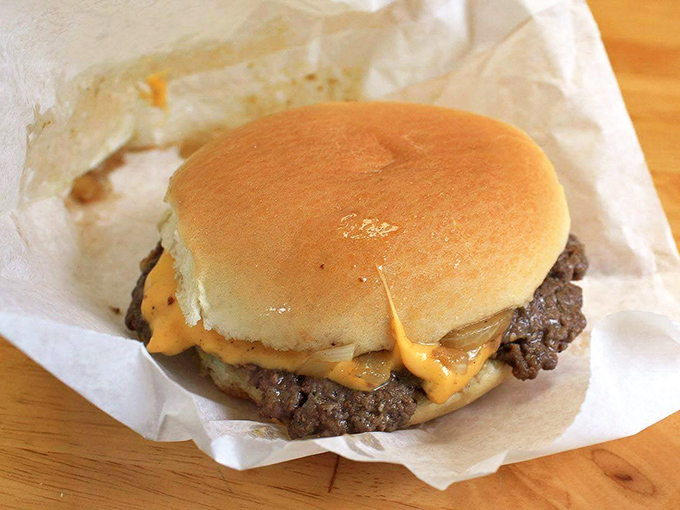 The slider-style burger in its purest form—a juicy patty, melted American cheese, and a soft bun. No distractions, just deliciousness.