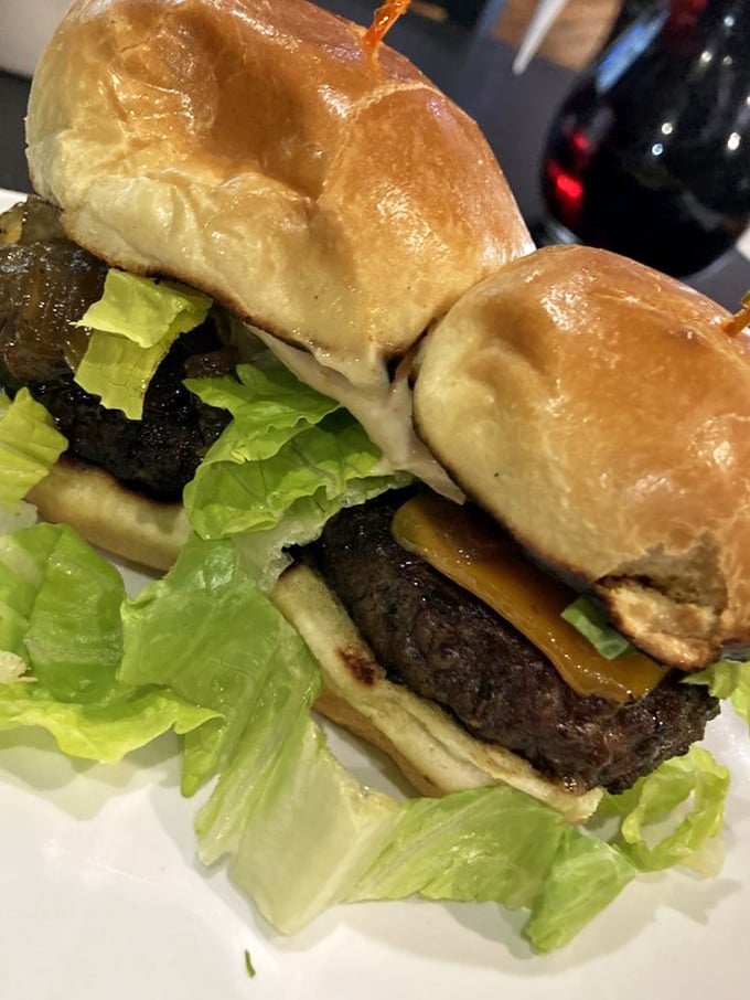 These aren't just burgers—they're handheld happiness. The pillowy bun embraces a perfectly seasoned patty like they were made for each other.