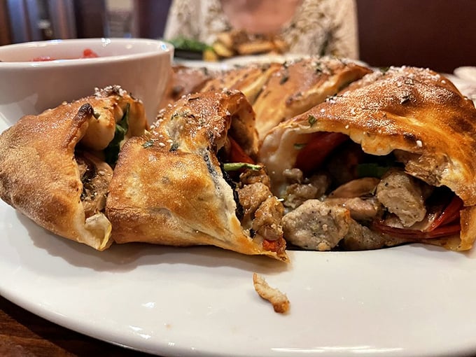 Behold the legendary stromboli in its natural habitat—golden-brown, bursting with fillings, and practically begging to be photographed before devoured.