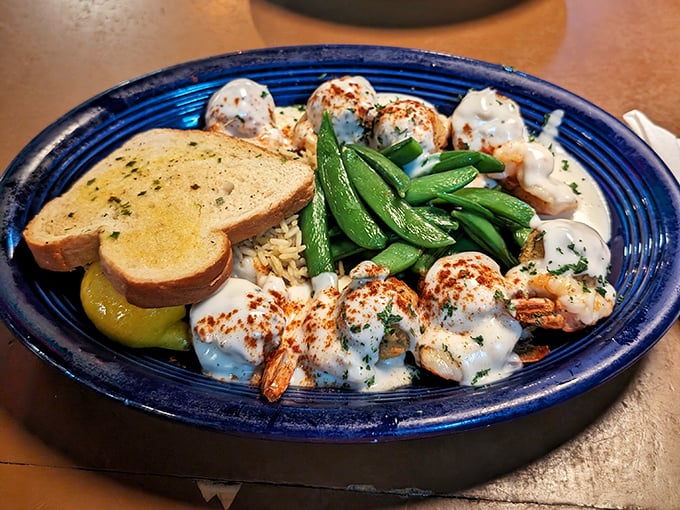 These shrimp nestled in creamy sauce aren't just dinner—they're a religious experience with garlic bread for communion and snap peas for salvation.