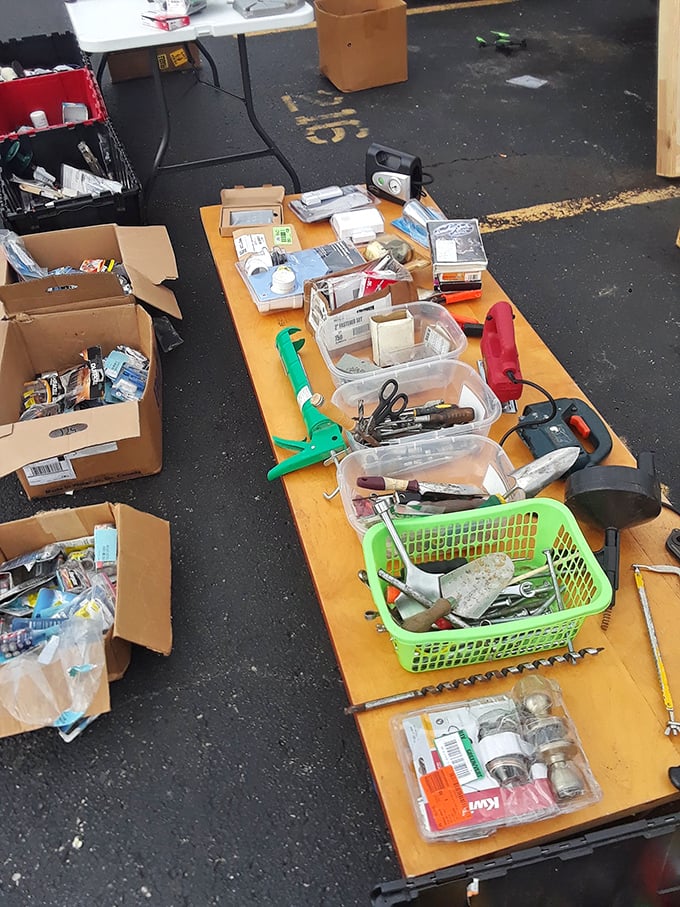 A handyman's dream buffet! Every tool imaginable spread across tables like a hardware store exploded and organized itself by happy accident.